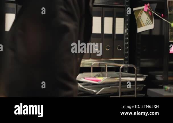 Law officer reviewing clues and proof in agency evidence room ...