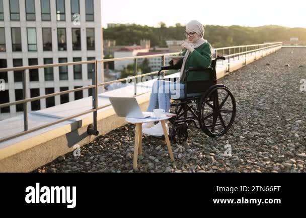 Side view of attractive muslim lady with disability eating healthy food ...