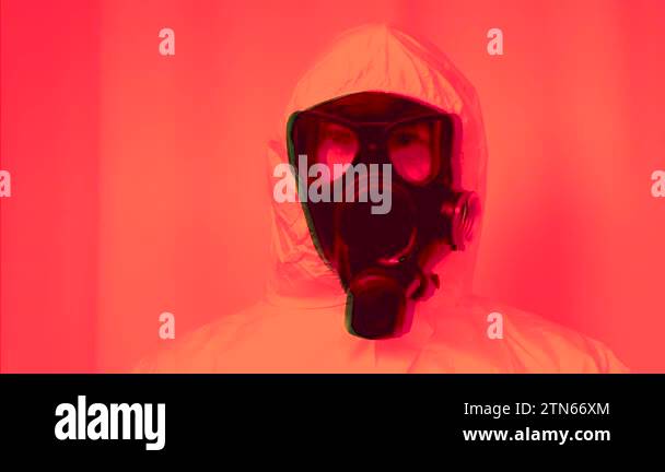 Man in a gas mask. Flickering red, threat of infection. A man in ...