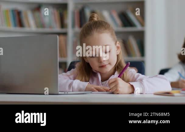 Diligent preteen learner. Close up portrait of cute little girl pupil ...