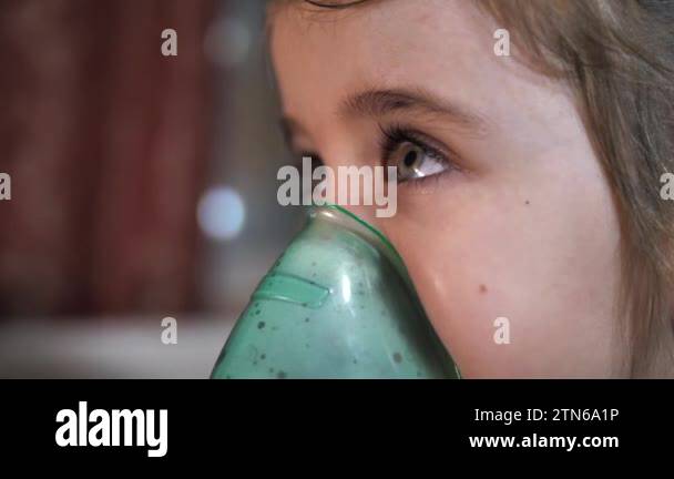 Mom treats her daughter with inhalation. Treating a child for a cold at ...