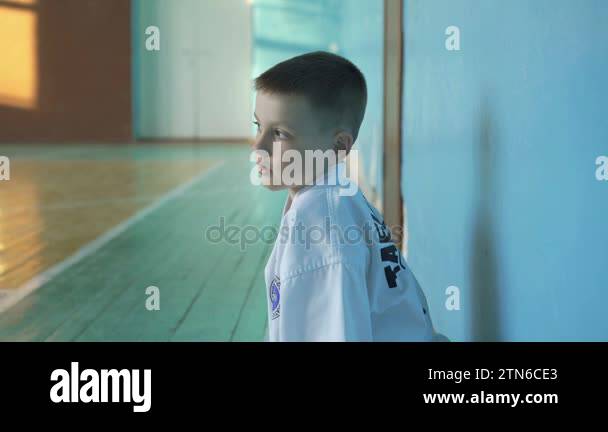 Look of funny young boy lying on the floor and does split in the gym 4K ...