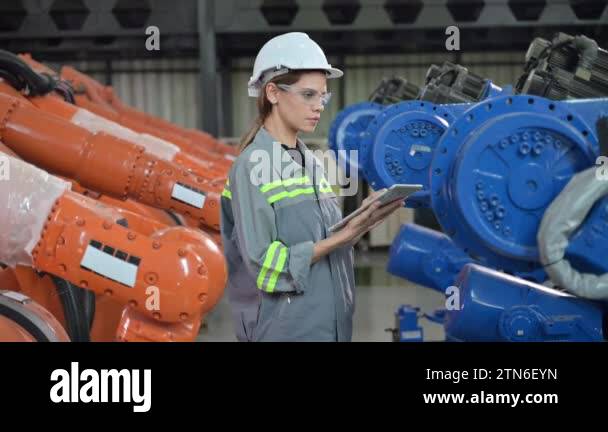 Maintenance engineer worker working with robotic machine automation at factory, Female ...
