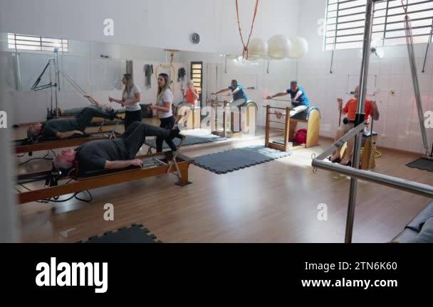 Group of elderly people exercising in Pilates Studio. old age workout ...