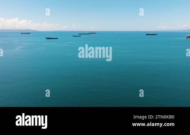 Seascape: Blue ocean water under blue sky. Ships in the deep sea ...