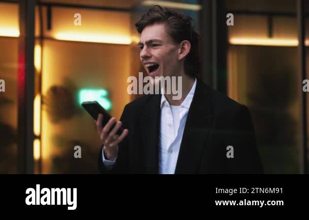 Angry and agressive man screams and talks on the phone, curses and ...