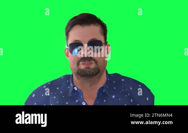 Fat man in blue suit and smokey glasses speaking front view on green ...