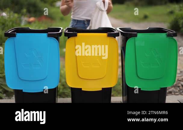 woman throwing and sorting an empty plastic trash in the recycling ...