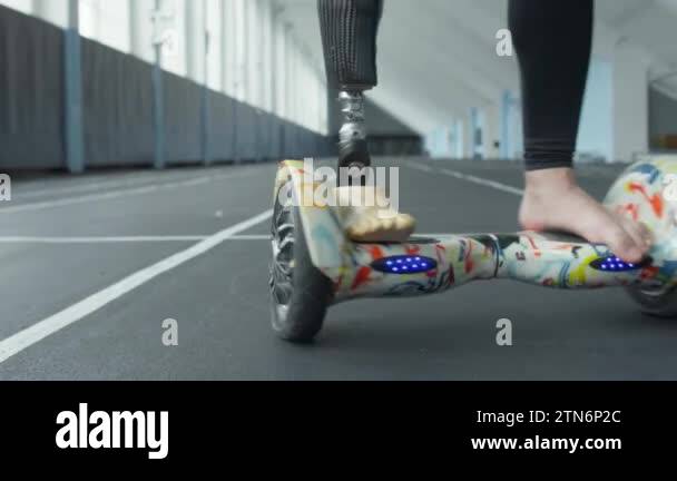 Close up shot of legs of barefoot man with prosthetic foot spinning on ...