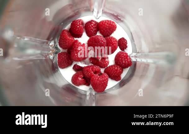 Raspberry and Milk Shake Mixed in High-Speed Blender in Slow Motion ...