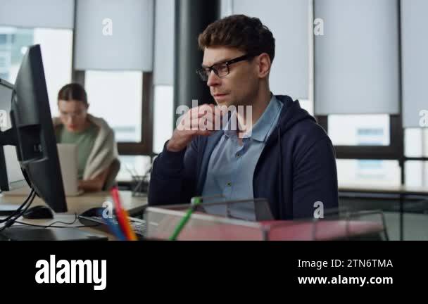 Thoughtful Programmer Looking Computer At Desk Focused It Man Analysing Code Searching Problem