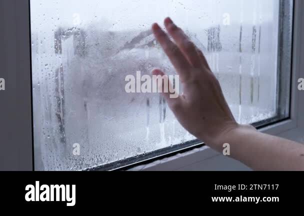 Female Hand Wipes the Dew, Condensate from a Wet, Misted Window ...