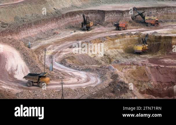 Excavators load ore into dump-trucks. This area has been mined for ...