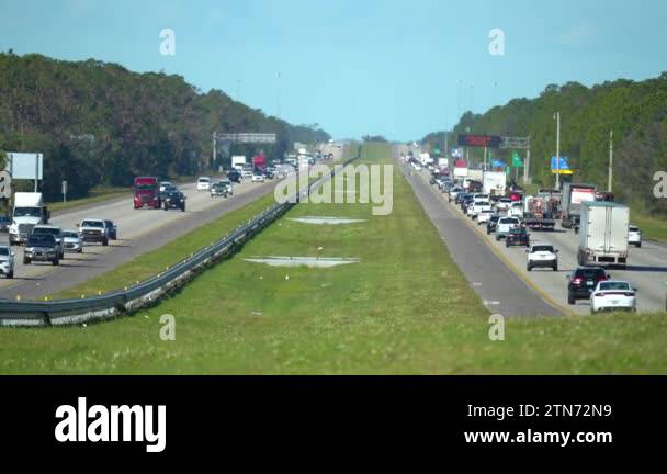 American wide freeway in Florida with dense traffic of driving cars ...