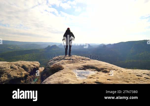 Tall tourist guide looking in paper map. Hiker is hiking with trekking ...