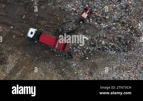 Garbage truck with tractor and bulldozer on the landfill site pile ...