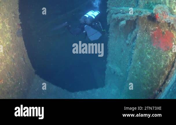 MEDITERRANEAN SEA, CYPRUS - AUGUST, 2019: Scuba divers swims on Shipwreck Swedish ferry MS ...