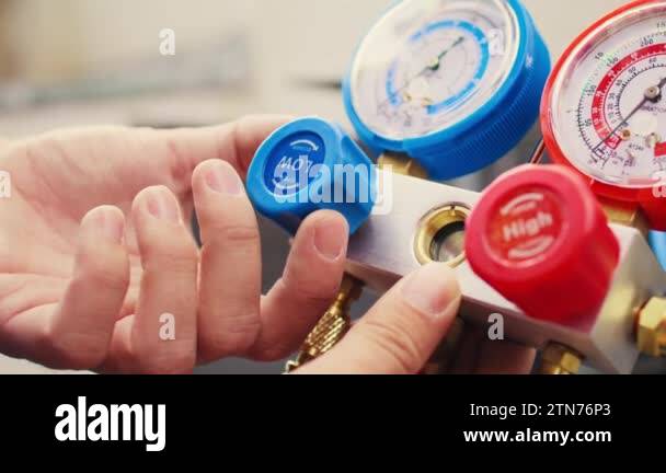 Extreme close up shot of repairman calibrating pressure measurement ...