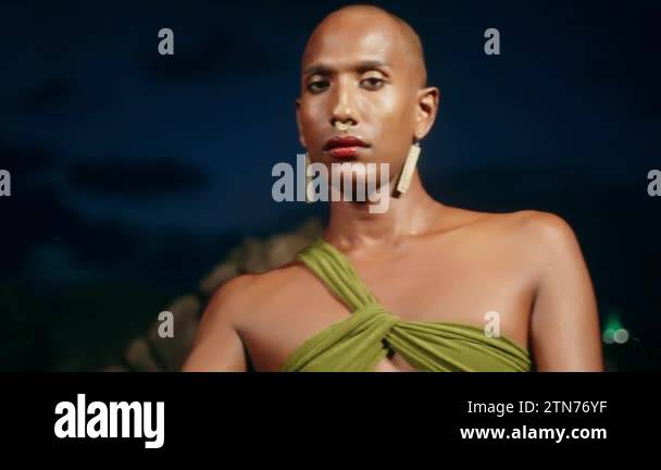 Lgbtq black person poses gracefully at night in scenic rocky location ...