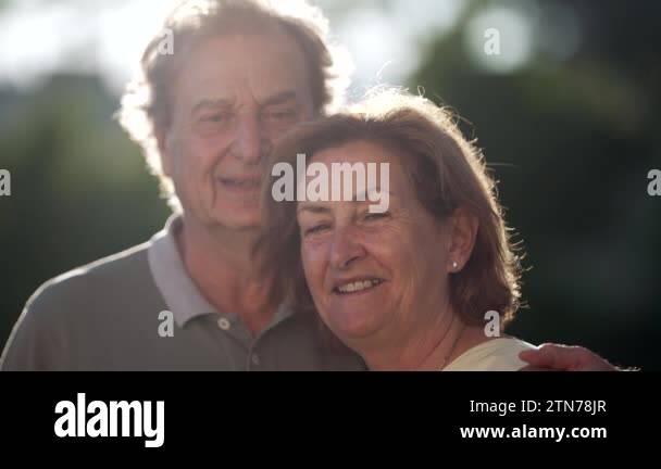 Two joyful older people smiling and laughing at camera. A senior ...