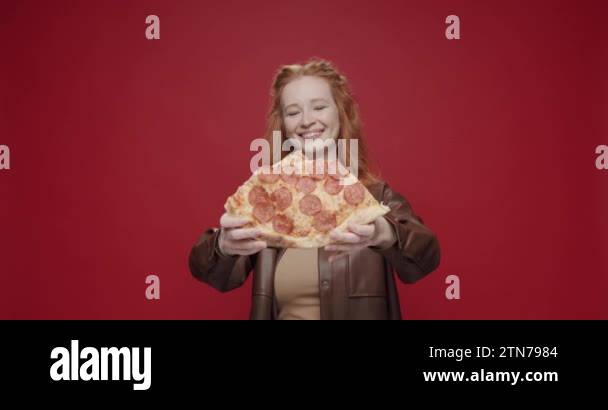 The beautiful hungry girl eating pepperoni pizza, enjoy and smile on ...