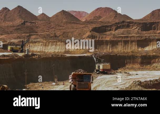 Excavators load ore into dump-trucks. This area has been mined for ...