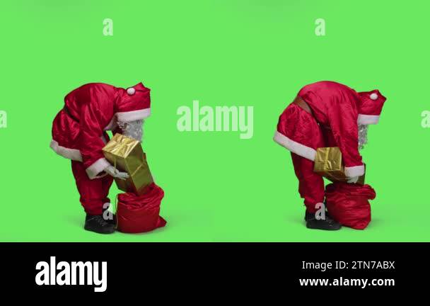 Saint nick preparing sack with presents for trip around the world ...