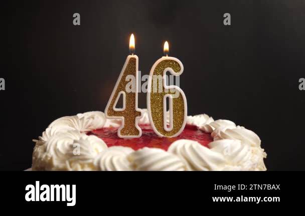 They blow out a candle in the form of the number 46, which is stuck ...