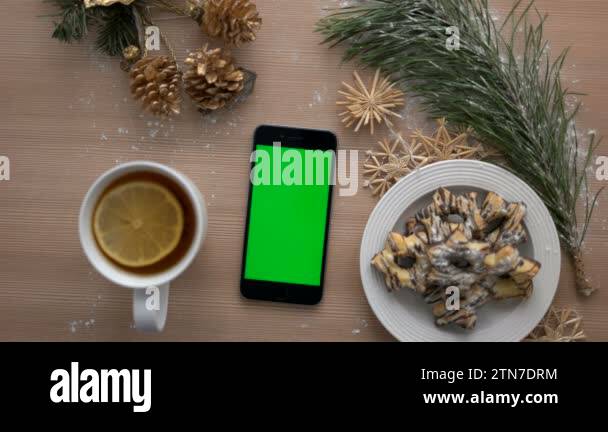 Top view man hand using smart phone with green screen. Finger tapping ...