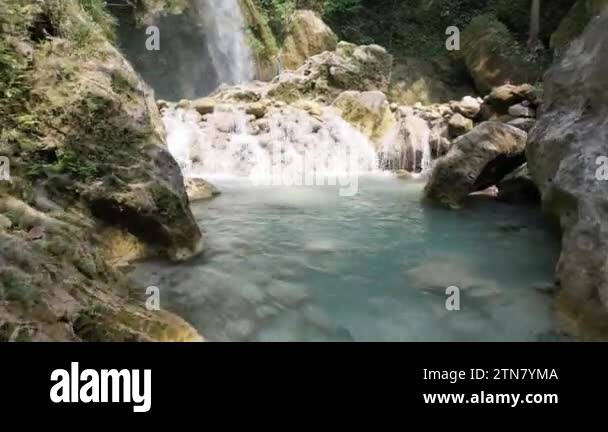 Drone footage of a beautiful waterfall in the Philippines with blue ...