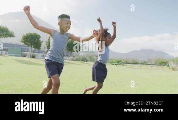 Video of happy african american schoolchildren high fiving in field ...