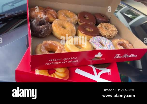 Large Open Box Of Tim Hortons Donuts In Contrasted Light With A
