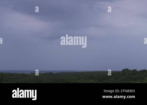 Lightning flash in storm clouds. Heavy clouds bring multiple flashes of ...
