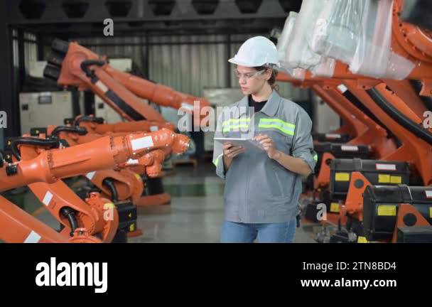 Maintenance engineer worker working with robotic machine automation at factory, Female ...
