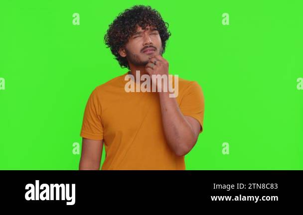 Eureka. Inspired young indian man pointing finger up with open mouth ...