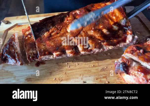 grilled pork ribs close-up. pork ribs on a rotating grill close-up ...