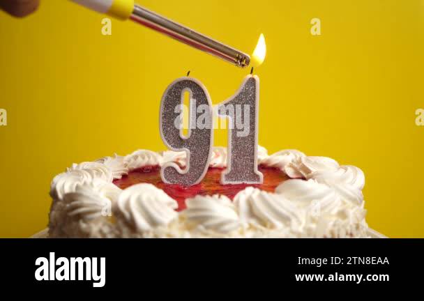 A candle in the form of the number 91, inserted into the holiday cake ...