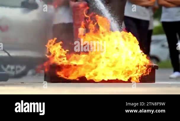 fireman Firefighters spraying water onto a burning pit Rescue trained ...