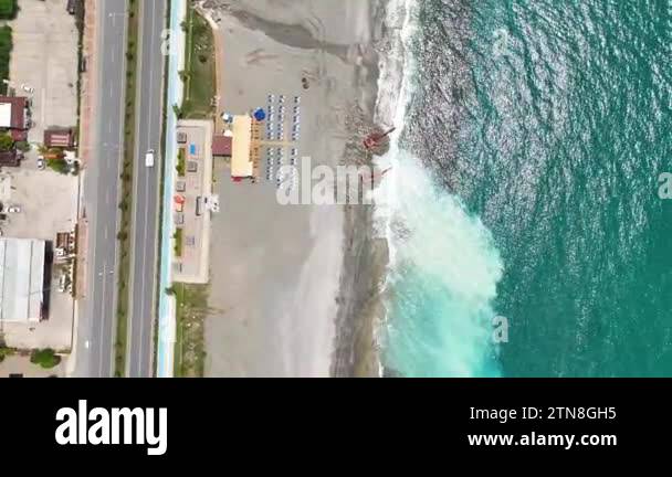 Gain a birds-eye view of a beach construction project where powerful ...