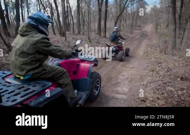 Extreme vacation in the woods on the ATV. Men engage in motor sport ...