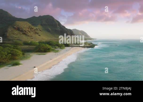 Makua beach at sunset, Oahu. Drone flying above cinematic ocean beach ...