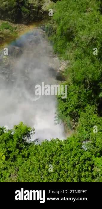 Flying over the waterfalls with beautiful cascades which made a mist ...