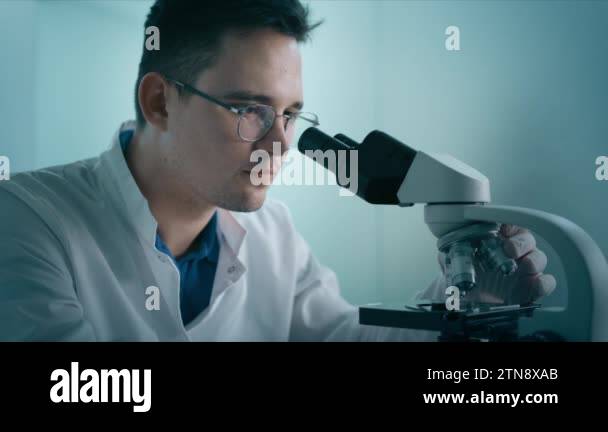 Smart scientist working with High Tech Equipment. Slow motion bright ...