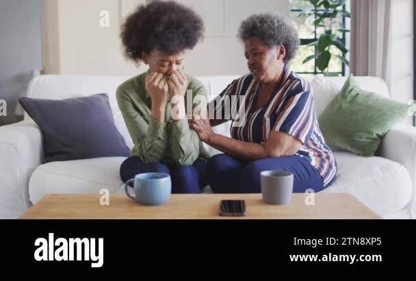African american senior mother comforting sad, crying adult daughter at ...