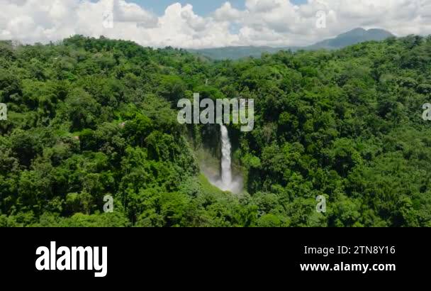 A beautiful waterfall among the rainforest and vegetation. Hikong Bente ...