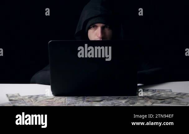 A hacker in a hood earns money. Cyber crime Stock Video Footage - Alamy