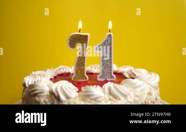 A candle in the form of the number 71, stuck in a holiday cake, is ...