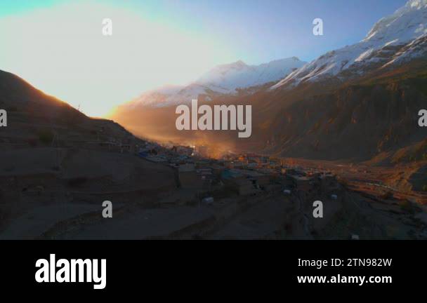 Birds eye view fly over Manang village house rooftops with beautiful ...