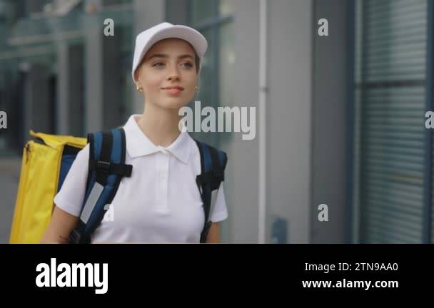 Female Courier Walking with Bicycle near Office Centre in Downtown. Woman Holding Pizza in Her ...