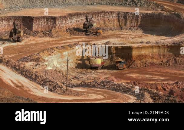 Excavators load ore into dump-trucks. This area has been mined for ...